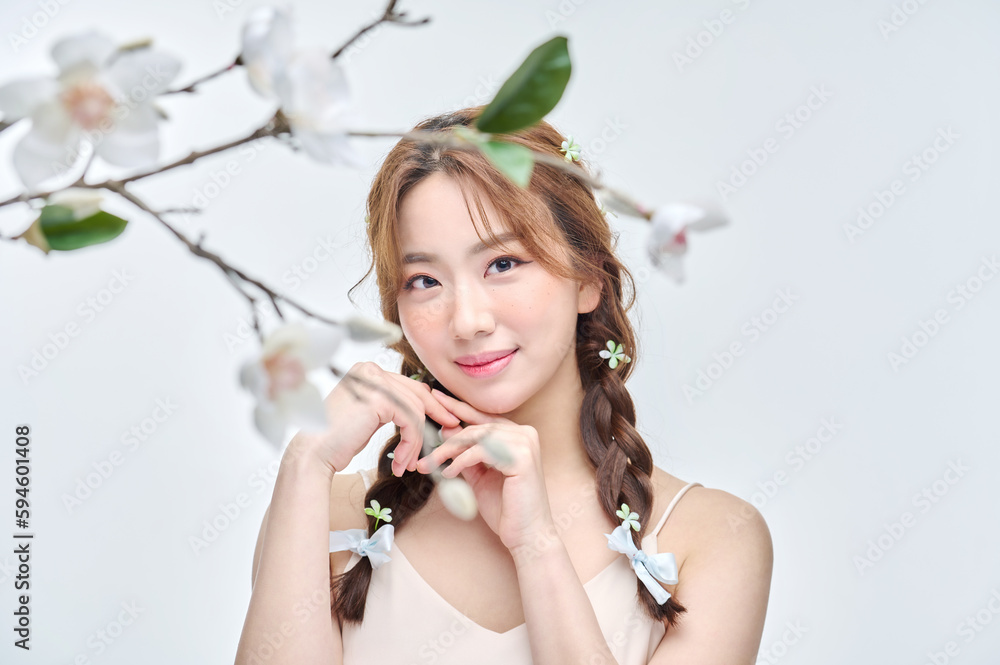 Beautiful Young Asian woman behind flower in beauty pose. Pretty girl ...