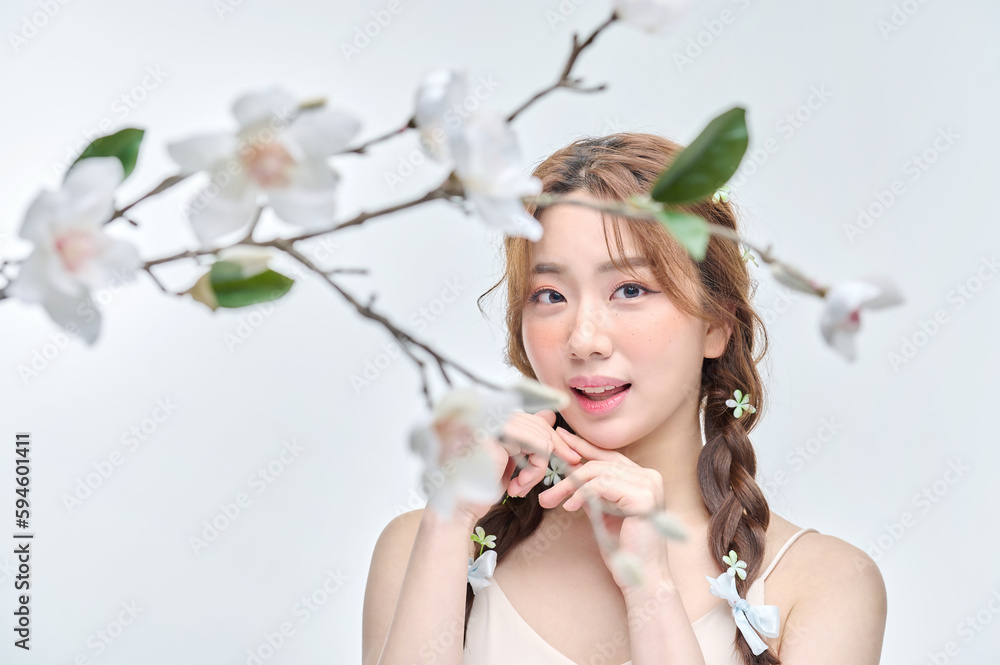 Beautiful Young Asian woman behind flower in beauty pose. Pretty girl ...