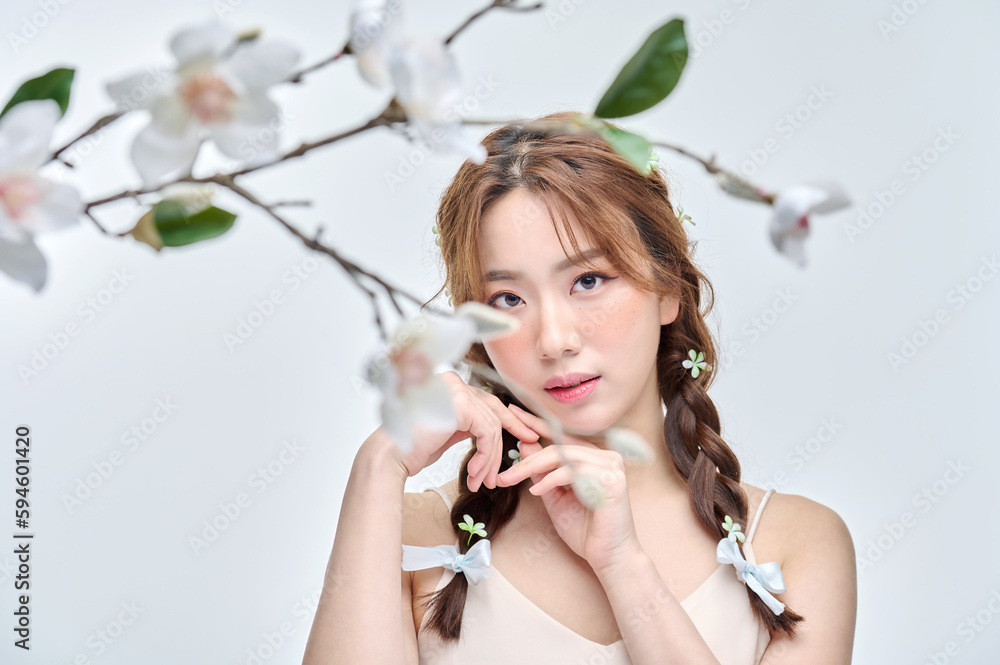 Beautiful Young Asian woman behind flower in beauty pose. Pretty girl ...