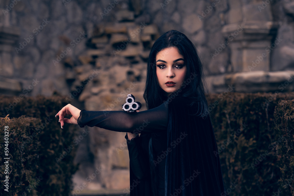a woman in a black outfit and boots posing for a picture in front of a ...