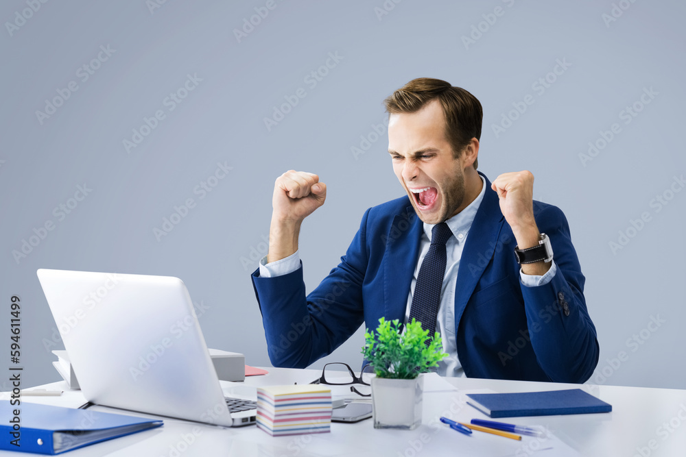 Wow! Very happy businessman in blue suit, working with laptop computer ...