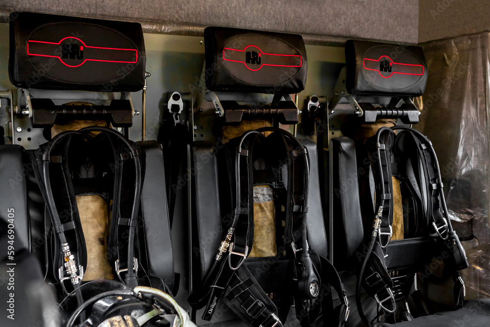 Seats for firefighters in a firetruck. Interior view of a fire engine ...