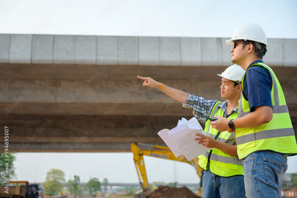 Asian male highway engineering working with architects talking and ...