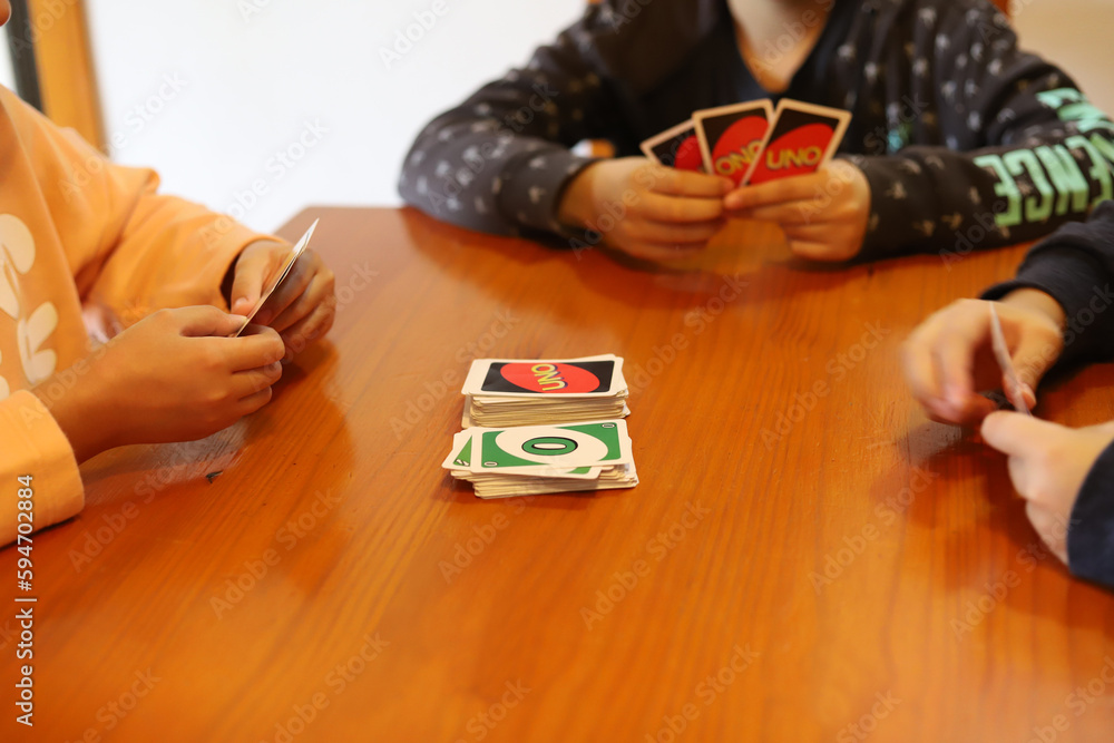 Group of children playing cards. Boys playing card game UNO. Board game ...