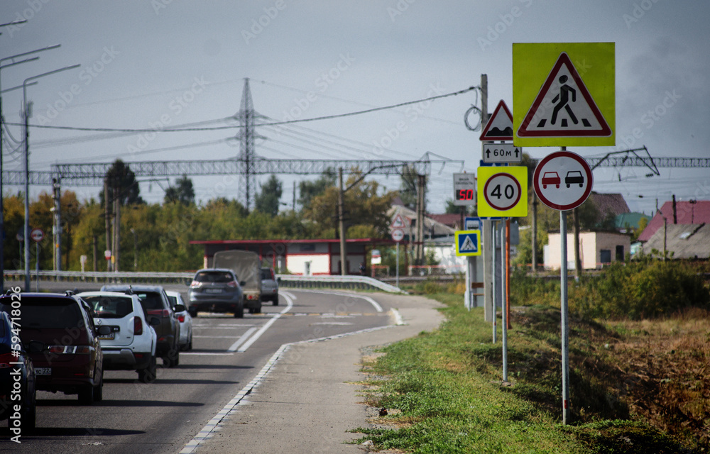 A series of road signs stands on a busy highway on a summer day Stock ...