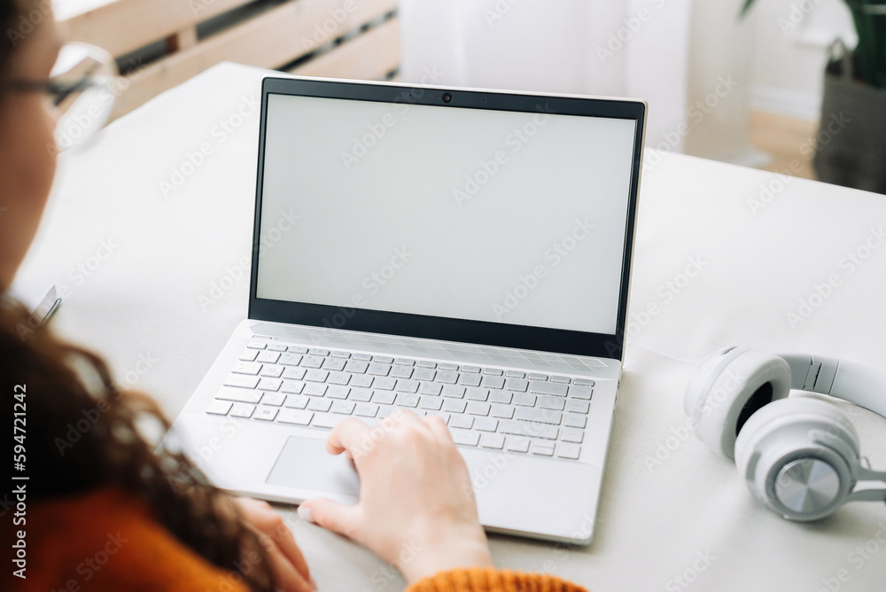 Over shoulder view of woman student elearning looking at white mock up ...