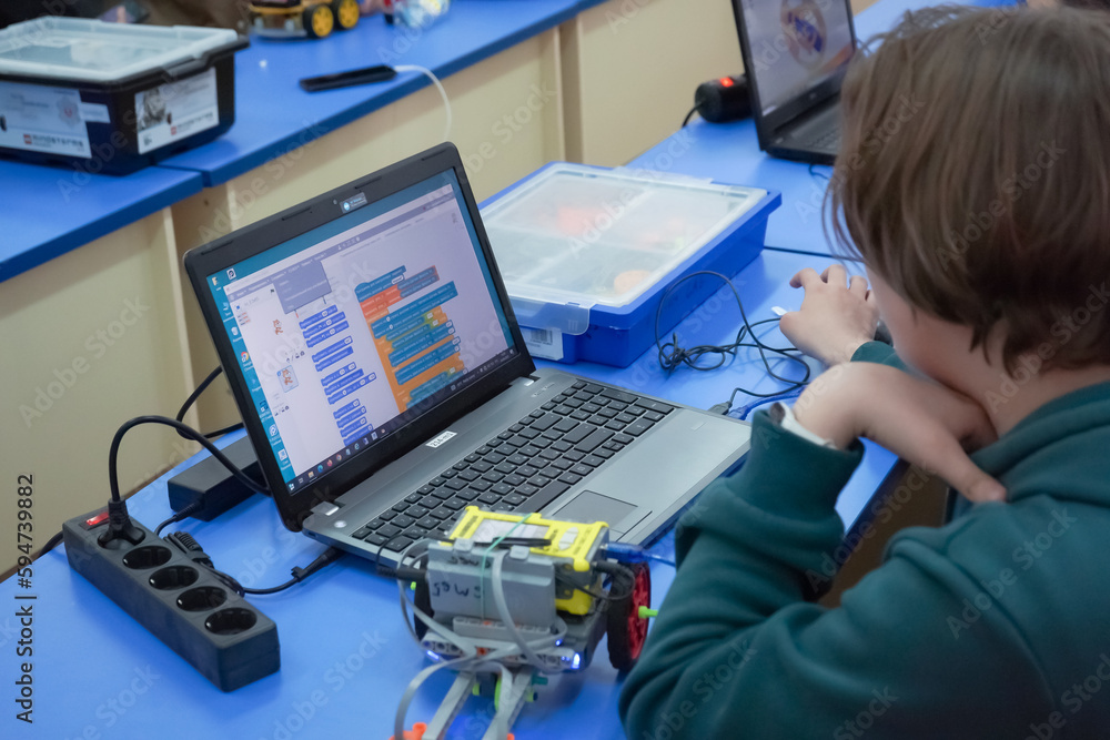 Children build and program construction robots at a robotics lesson at ...