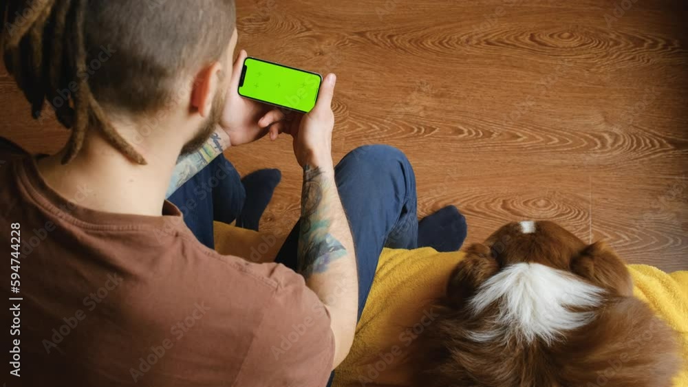 Using Mobile with Horizontal green screen Chroma Key Device. Young man ...