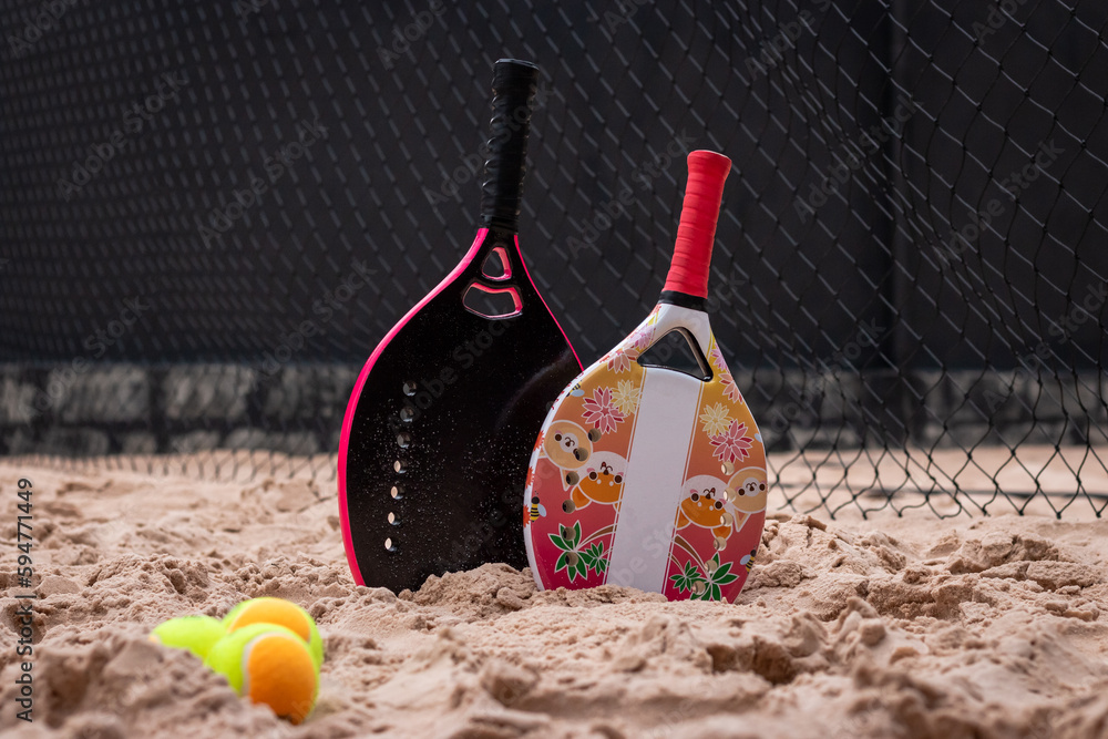 Beach Tennis Kids. Women's beach tennis rackets on the sand. Family ...