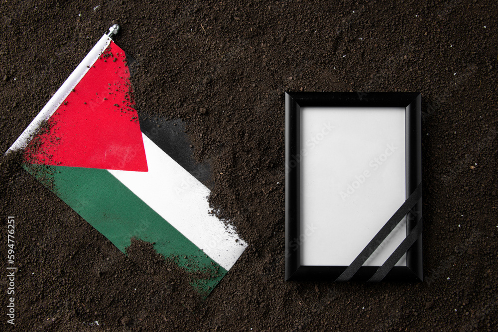 top view palestinian flag with picture frame on dark soil funeral death ...