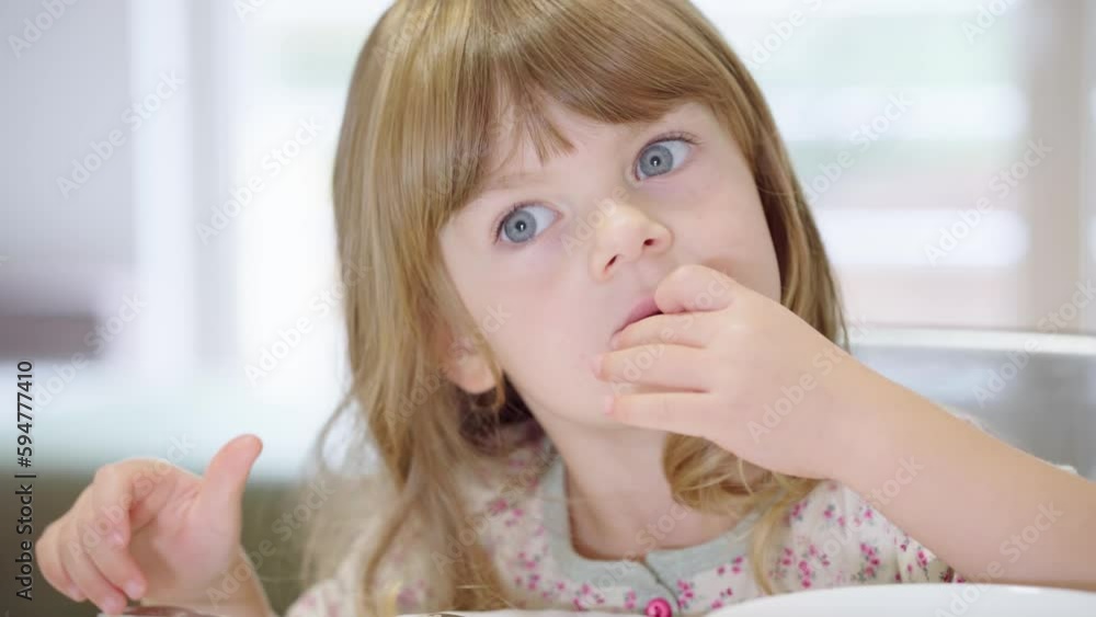 Child eats junk food. Little girl tastes unfamiliar food. Toddler chews ...
