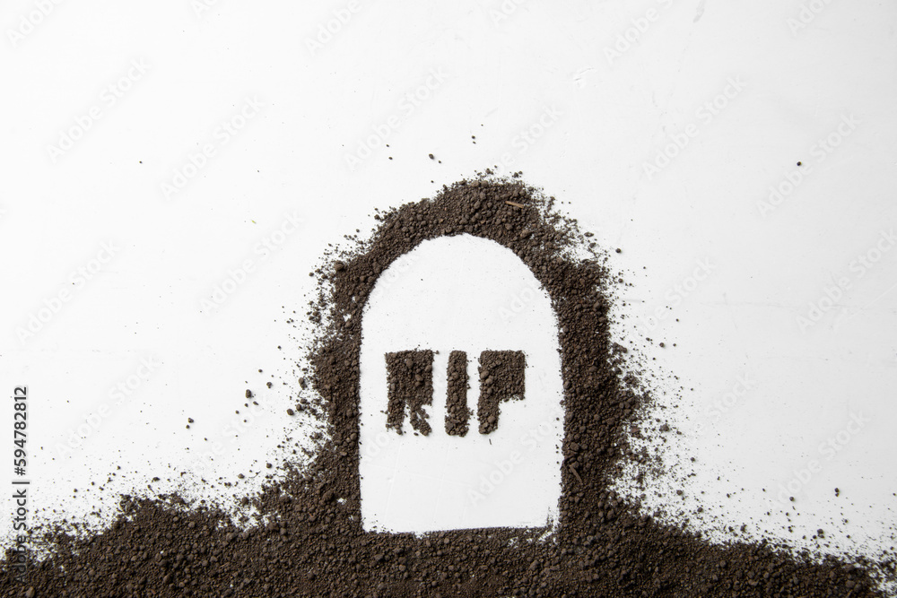 top view of rip inscription on grave shape with dark soil on white ...