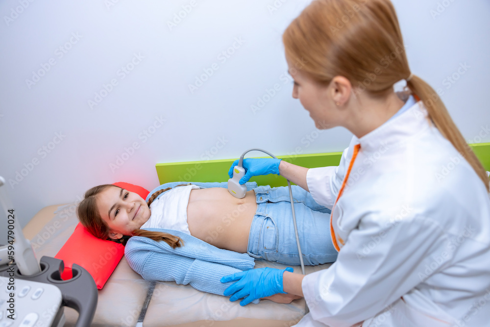 Doctor performing ultrasound scan on little girl medical specialist ...