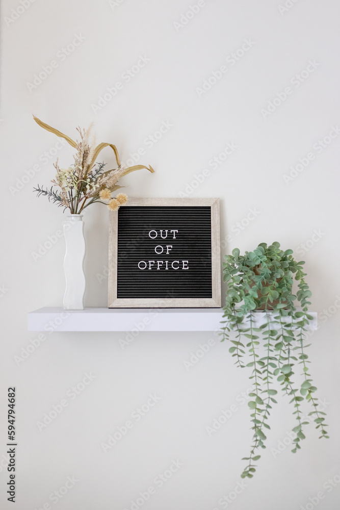Out of office lettering on a black and tan letter board sitting on a ...