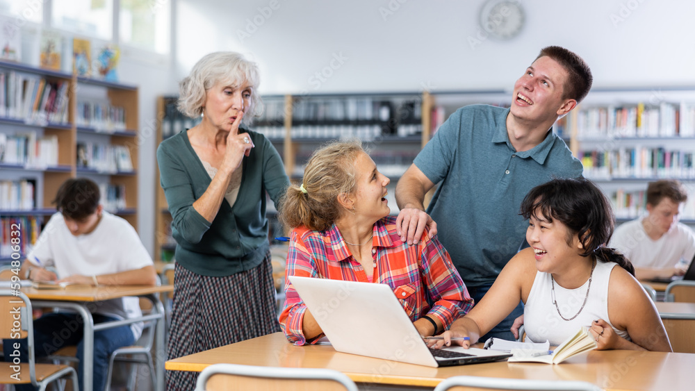 Adult librarian holding his finger on lips making silent gesture in ...