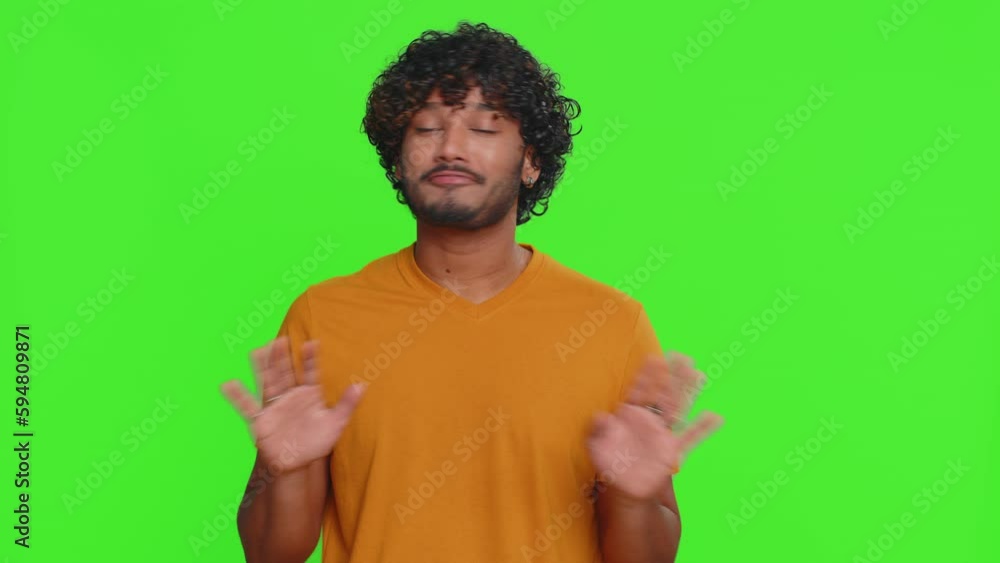 I am dont want it, not me. Confused young indian man pointing fingers ...