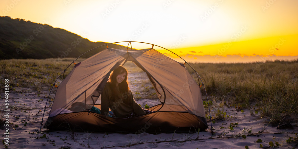 pretty girl camping in the tent on the sand dunes in new south wales ...