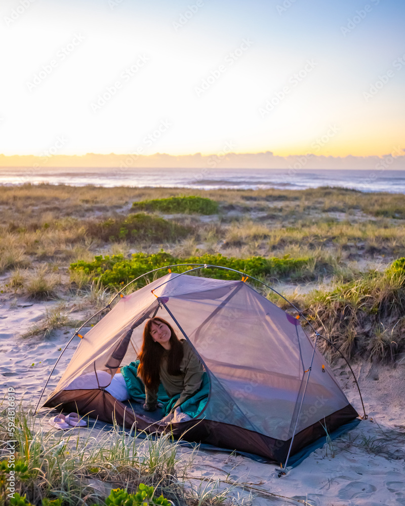 pretty girl camping in the tent on the sand dunes in new south wales ...