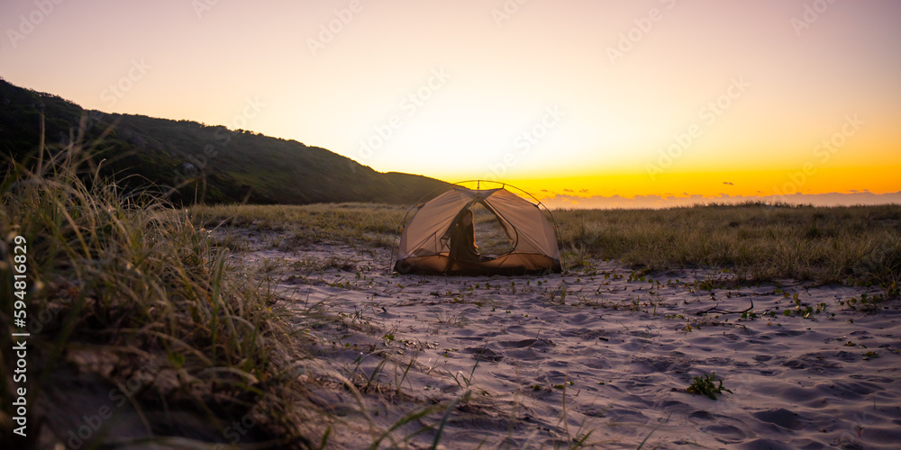 pretty girl camping in the tent on the sand dunes in new south wales ...