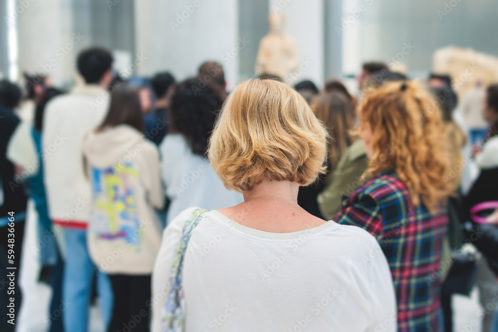 Group of students on excursion visit gallery museum with tour guide, a ...