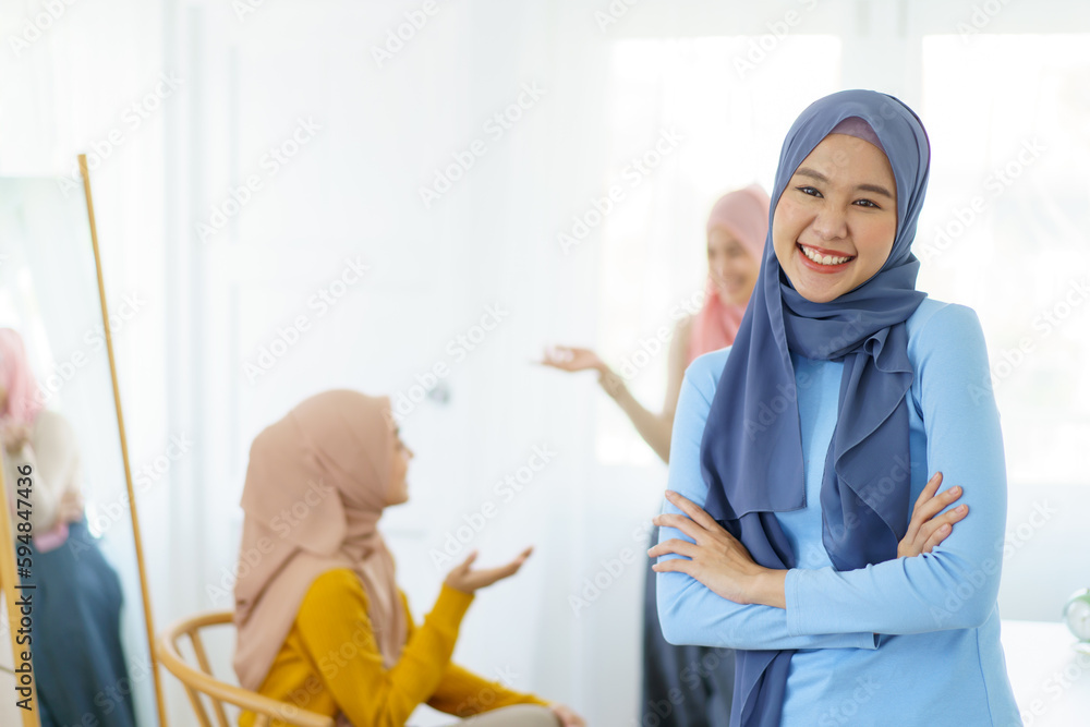 Happy Asian muslim businesswomen having a discussion together in office ...