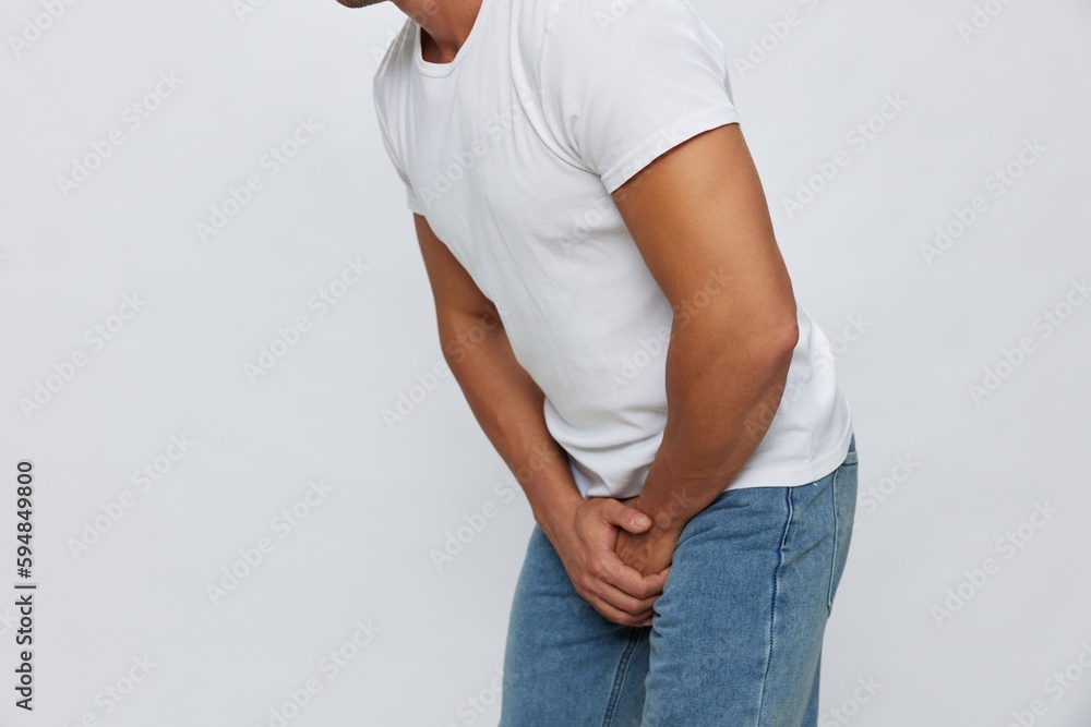 Man groin pain problems with potency and urination, urolithiasis, in white t-shirt on white ...