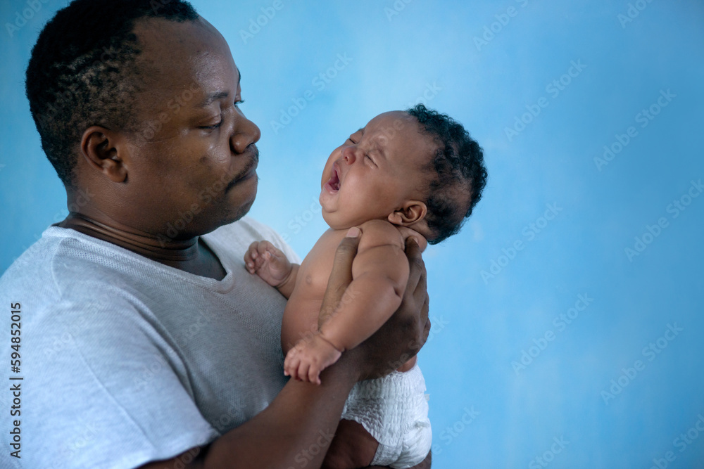 African father holds 3 months old baby girl in arms, baby was feeling ...