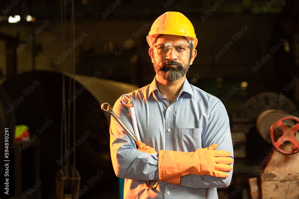 Young indian man engineer wearing safety yellow helmet and gloves ...