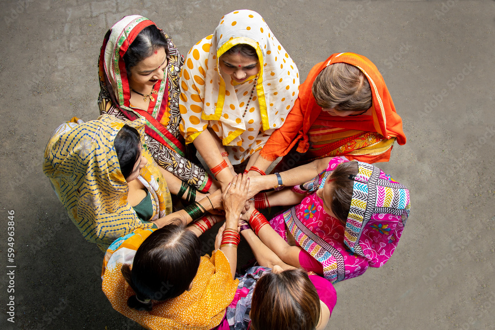 Group of happy young traditional indian women wearing colorful sari ...