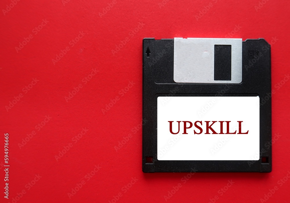 Floppy disk on red copy space background with tag UPSKILL - process of ...