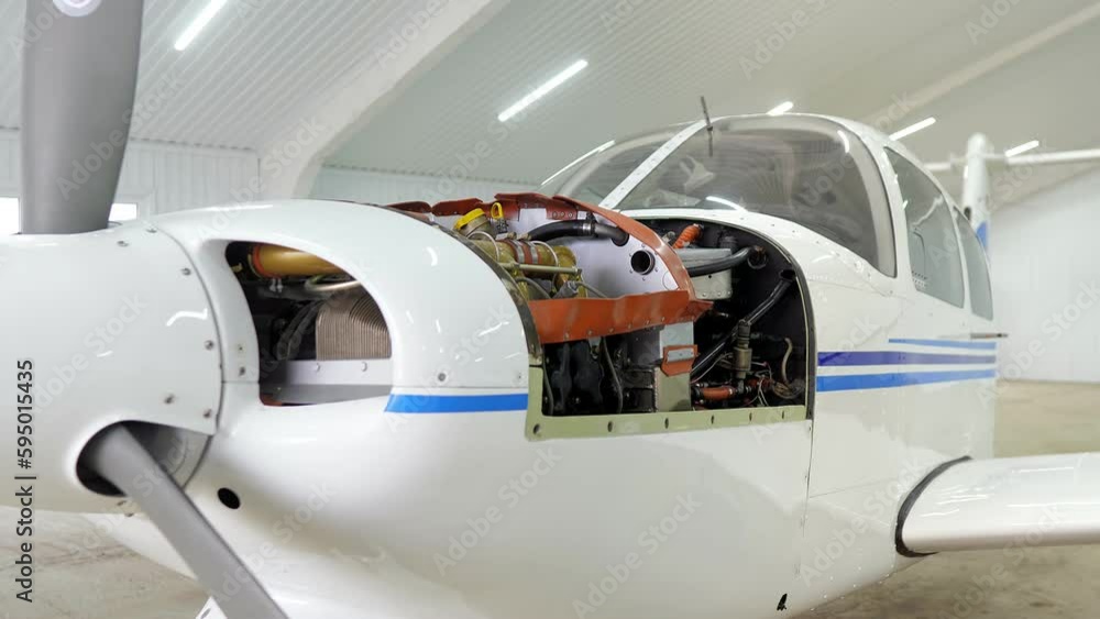 Single engine propeller airplanes parked in a closed aircraft hangar ...