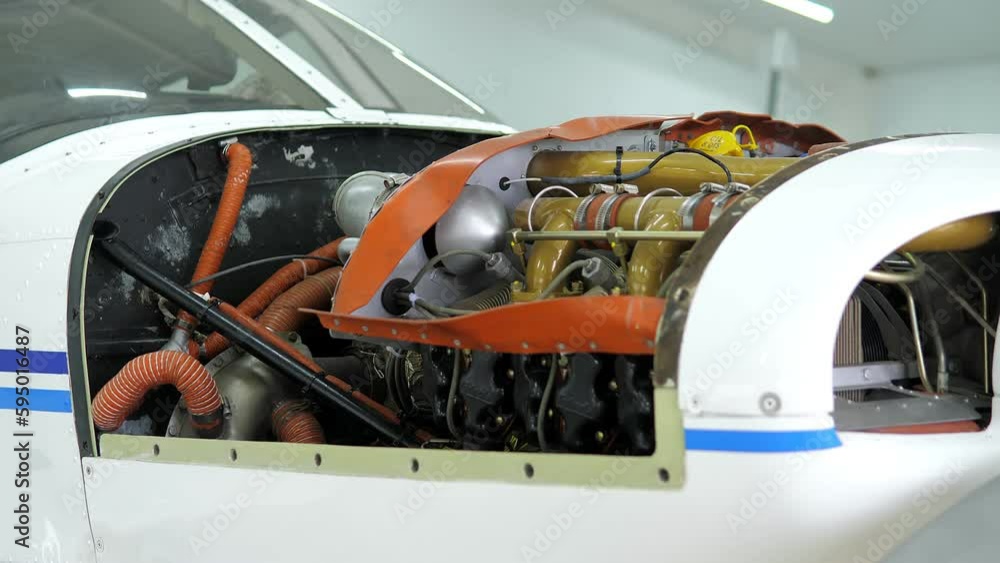 Single engine propeller airplanes parked in a closed aircraft hangar ...