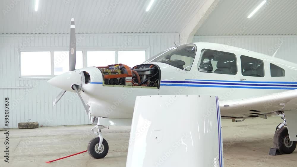 Single engine propeller airplanes parked in a closed aircraft hangar ...