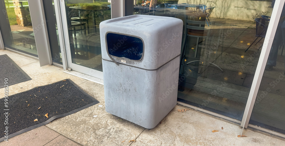overflowing trash can next to recycling bins symbolizes the importance ...
