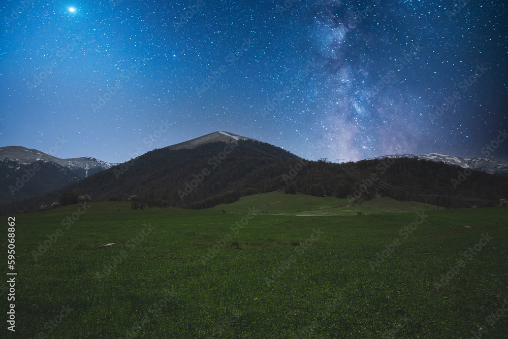 Beautiful night landscape, mountains and hills in the starry night with ...