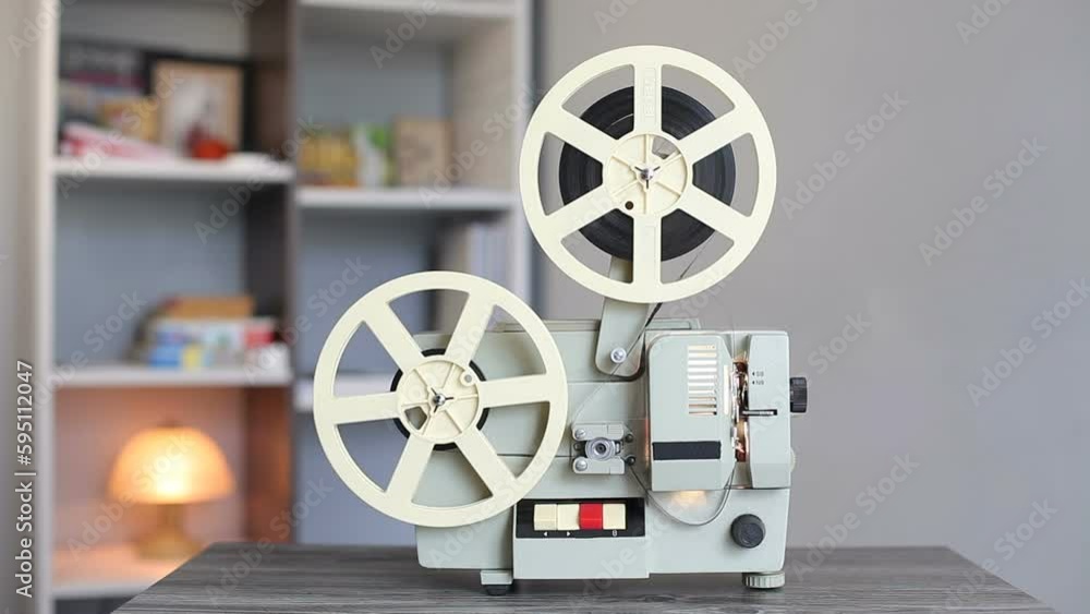 Reel old film projector, shows the film. The first two-format film ...