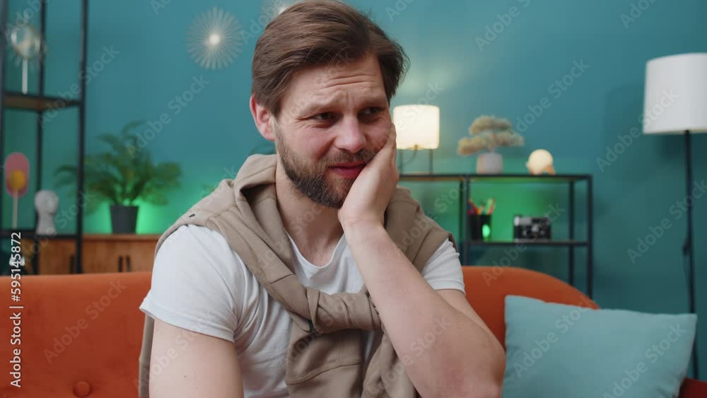 Dental problems. Young man touching cheek, closing eyes with expression ...
