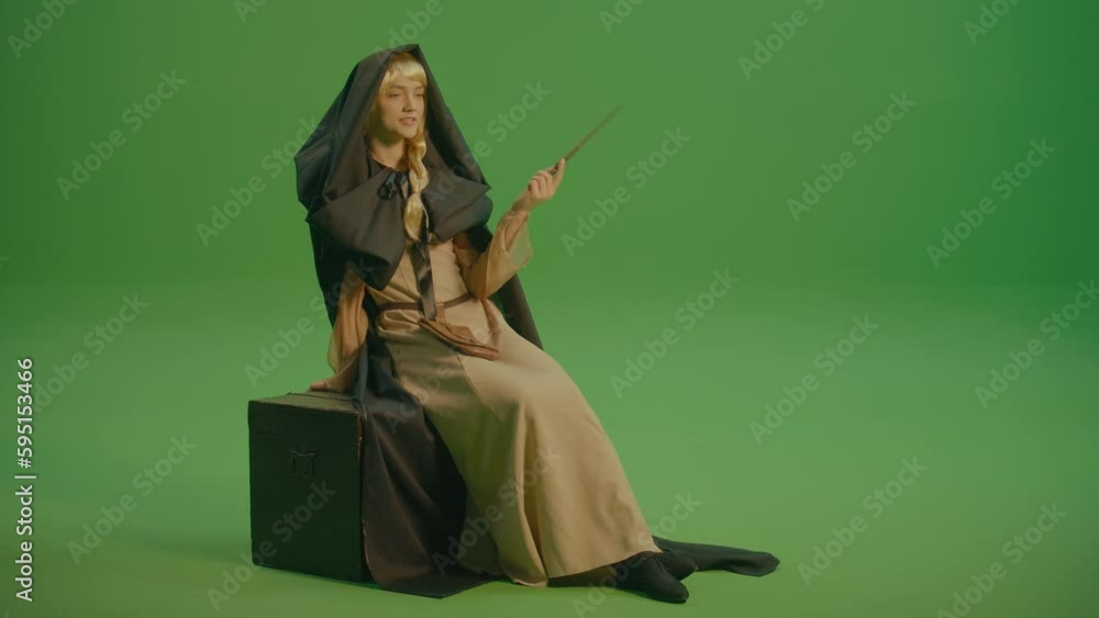 Green Screen. Woman Sorceress With a Magic Wand Sitting on the Magic ...