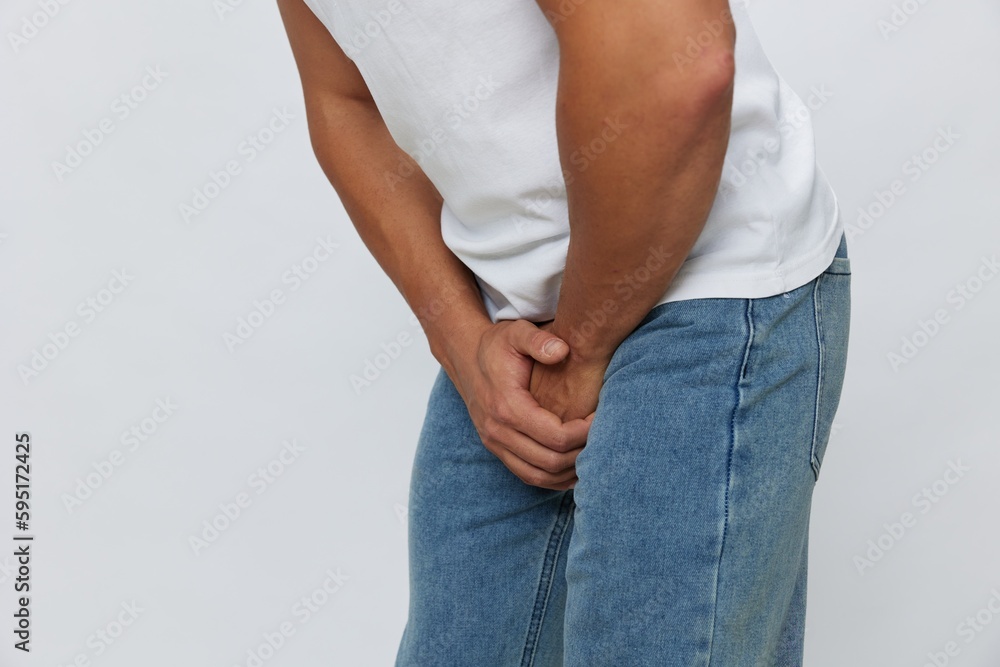 Man groin pain problems with potency and urination, urolithiasis, in white t-shirt on white ...