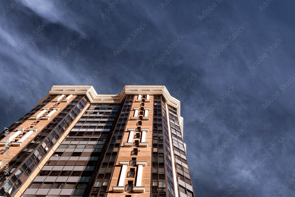 multi-storey building, view from below. A building against a dark sky ...