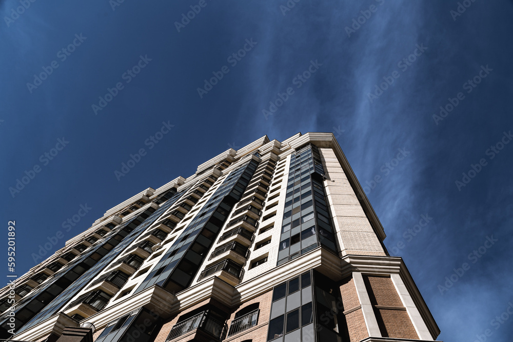 multi-storey building, view from below. A building against a dark sky ...