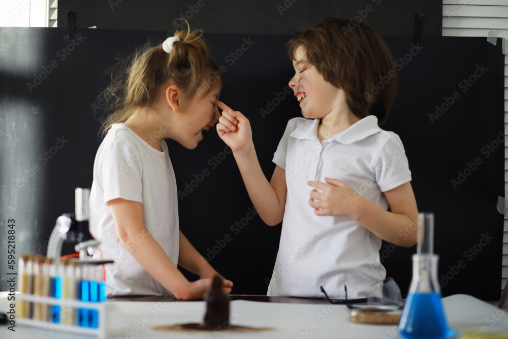 Children scientists. Schoolchildren in the laboratory conduct ...