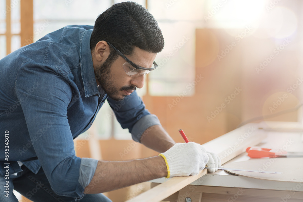 Professional male carpenter using measuring tool, metal square ...