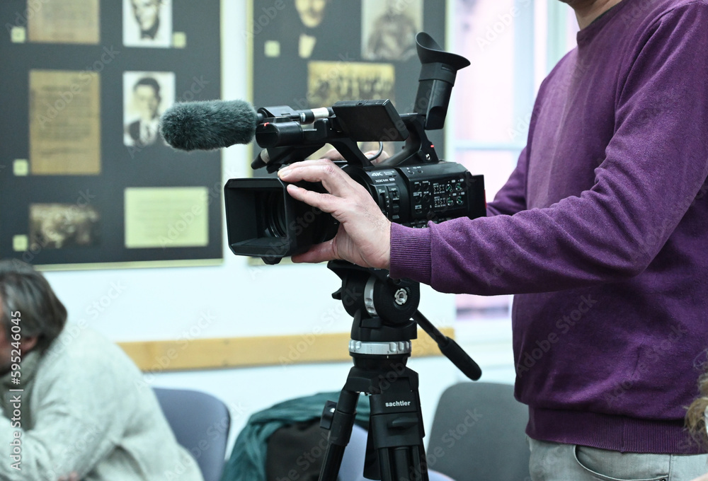 Cameraman on News conference. Filming and covering press event with a ...