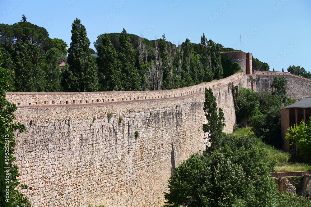 ancient fortress, a high stone fortress wall, a tower in the distance ...