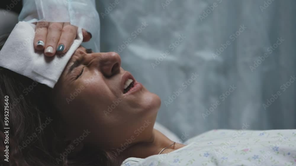 Female patient on operating table in hospital screaming in pain ...
