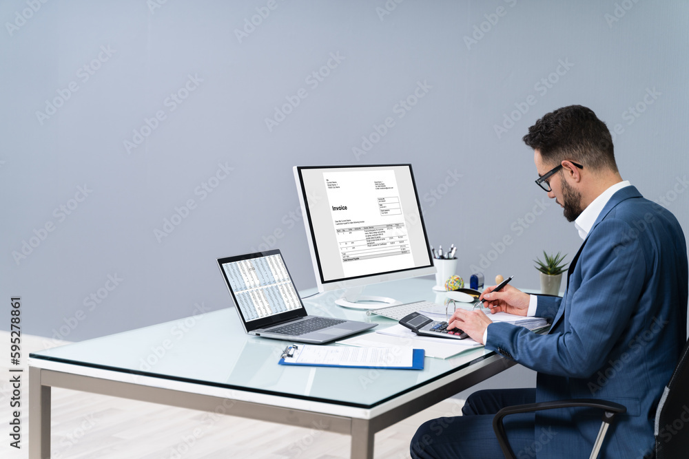 Accountant Making Invoice On Computer Stock Photo | Adobe Stock