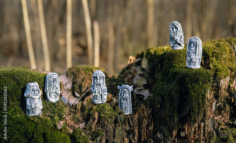 Antique ritual stone idols on tree stump close up, abstract natural ...