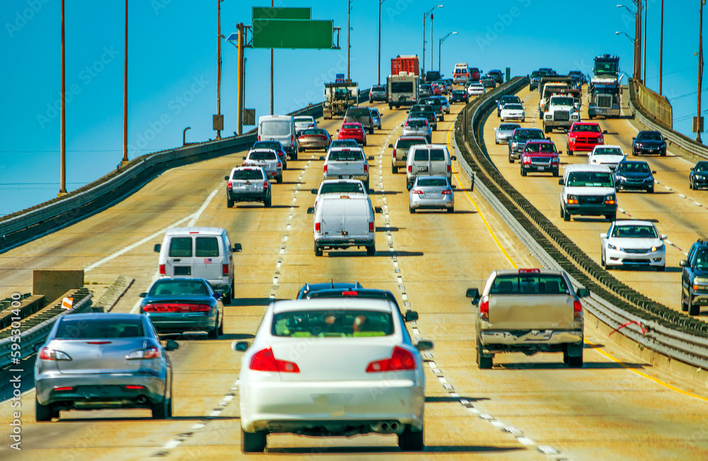 Car traffic over a major bridge, empty road signs on the left side ...