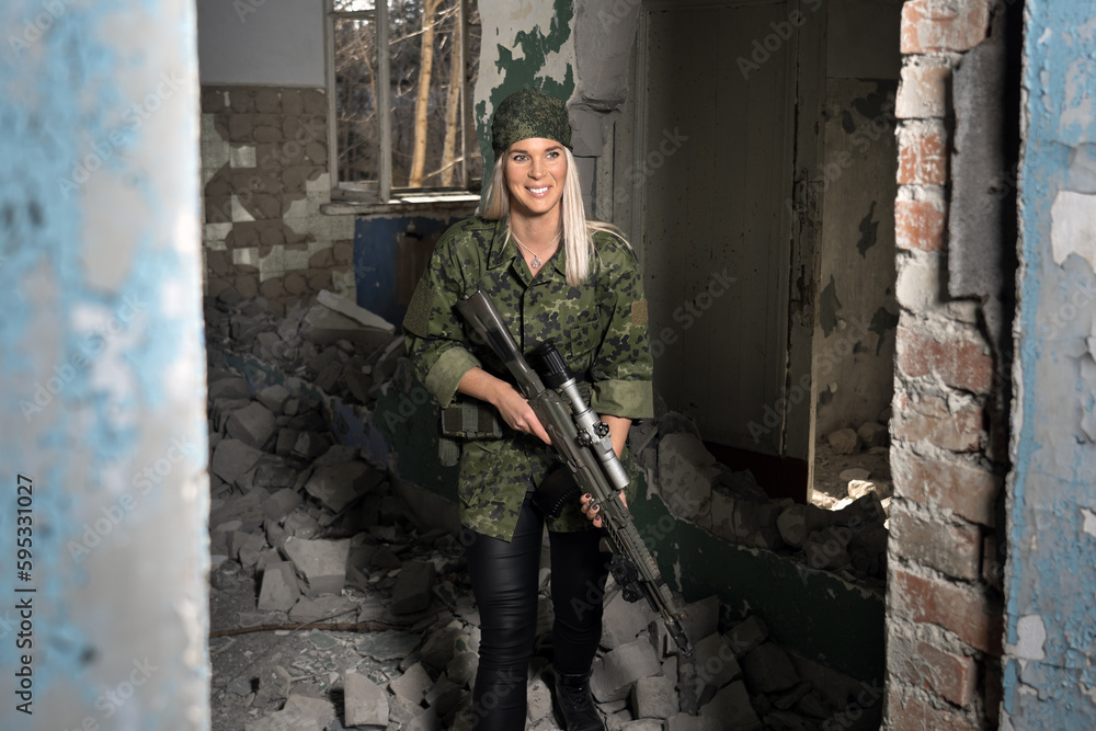 Girl sniper with a smile on her face with a sniper rifle in her hand in ...